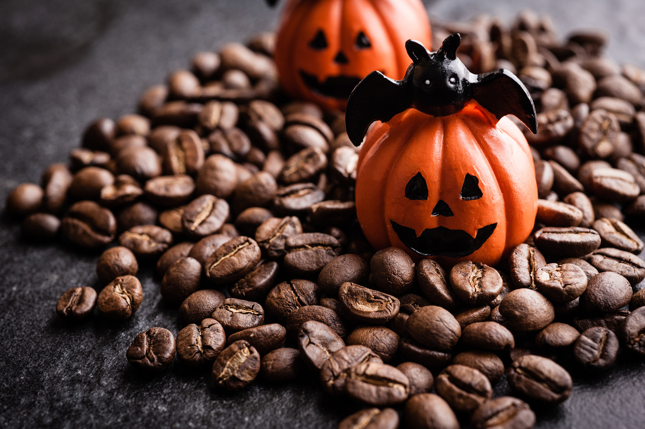Halloween pumpkin decoration with coffee beans on dark background ...